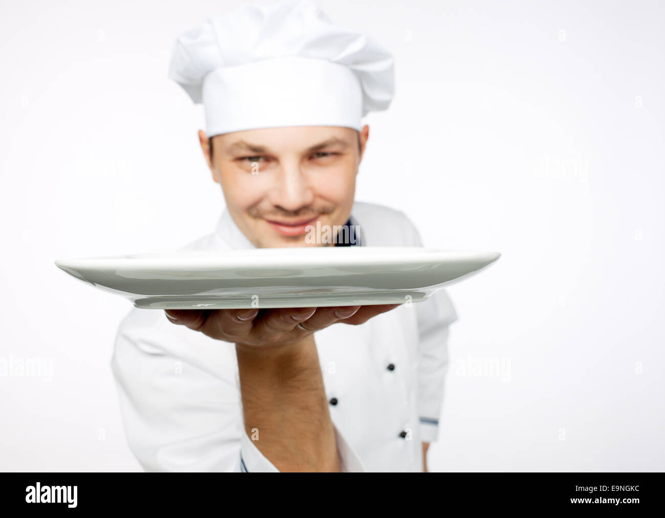 chef holding empty plate Stock Photo - Alamy
