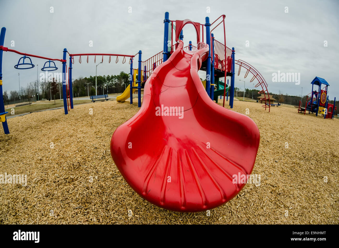 at a playground with a red slide Stock Photo - Alamy