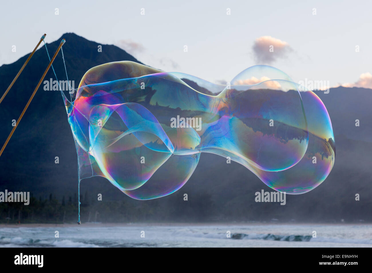 Man making large soap bubbles on beach Stock Photo - Alamy