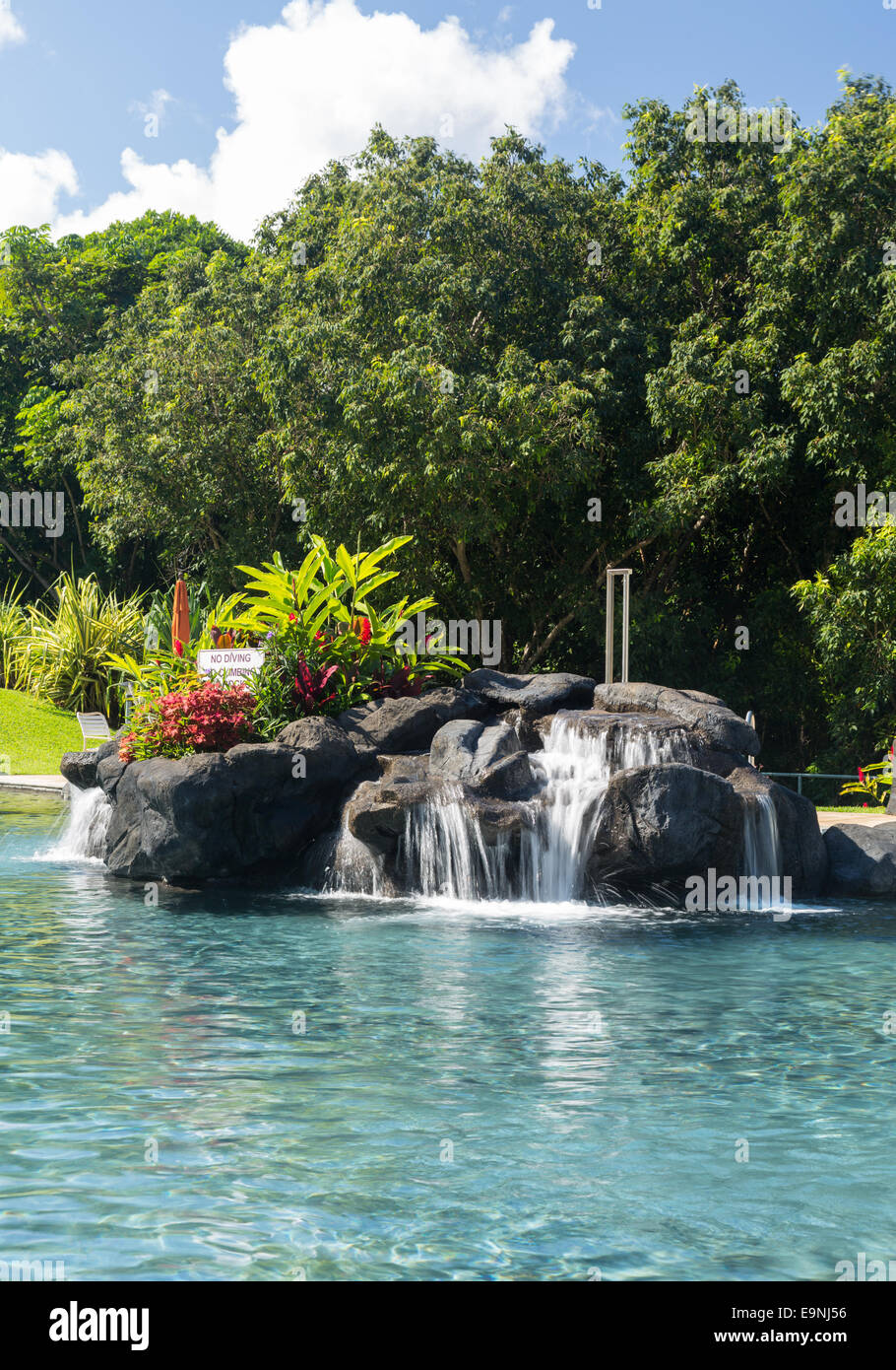 Hotel swimming pool with waterfall Stock Photo - Alamy