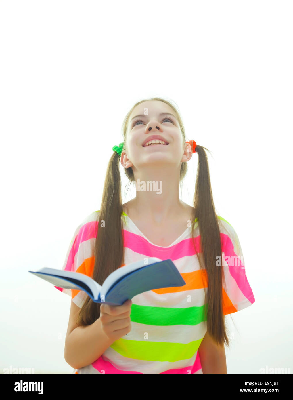 Teenage girl staying with a book Stock Photo - Alamy