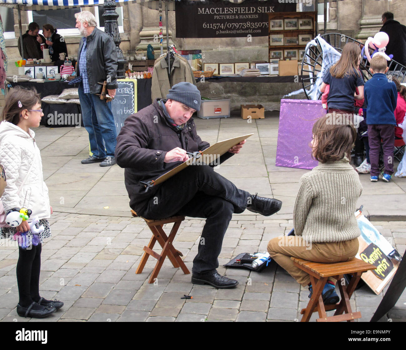 Outdoor portrait artist drawing a child at the monthly traditional ...