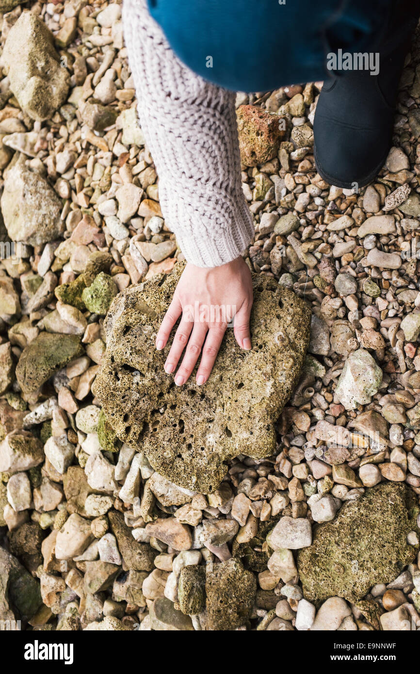 Woman touching big rock with her hand Stock Photo - Alamy