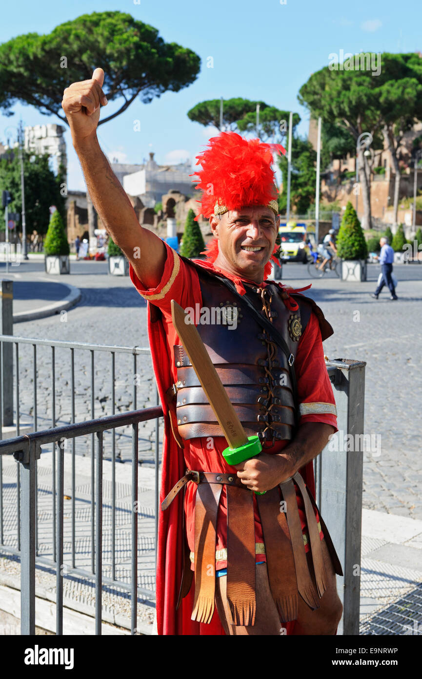 A man dressed as a Roman soldier with a wooden sword on the street of ...