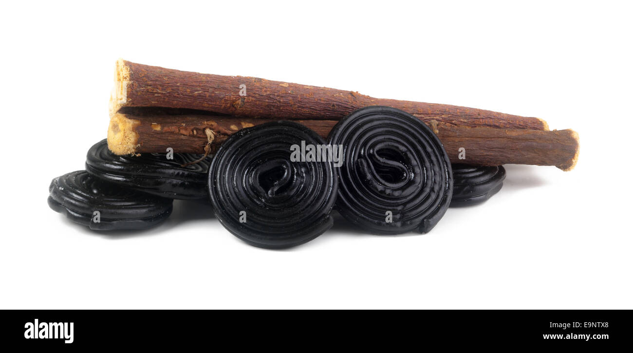 Licorice roots and licorice black on white background Stock Photo - Alamy