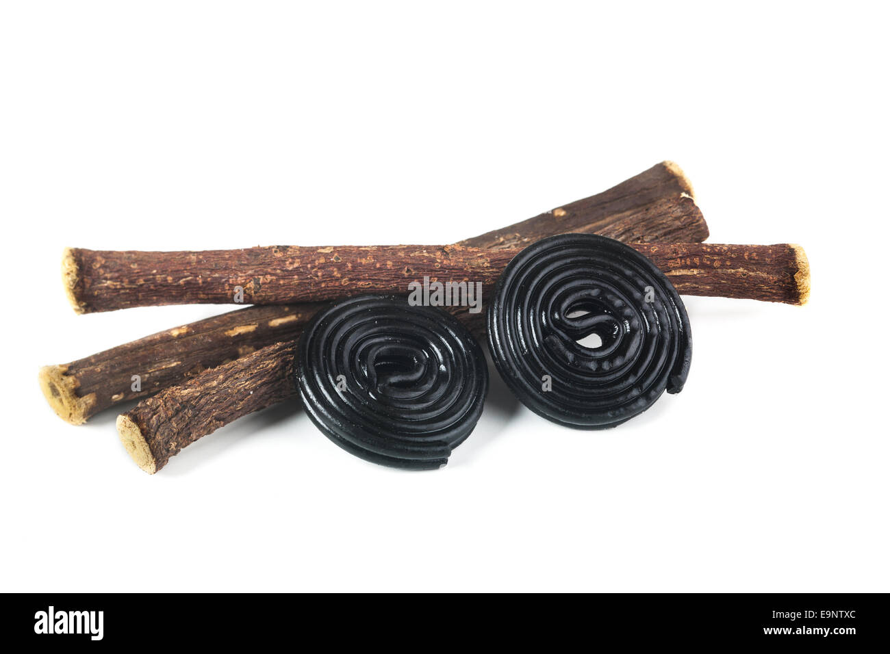 Licorice roots and licorice black on white background Stock Photo - Alamy