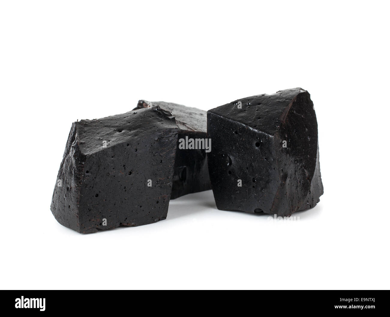 Pure blocks of black licorice on white background Stock Photo - Alamy