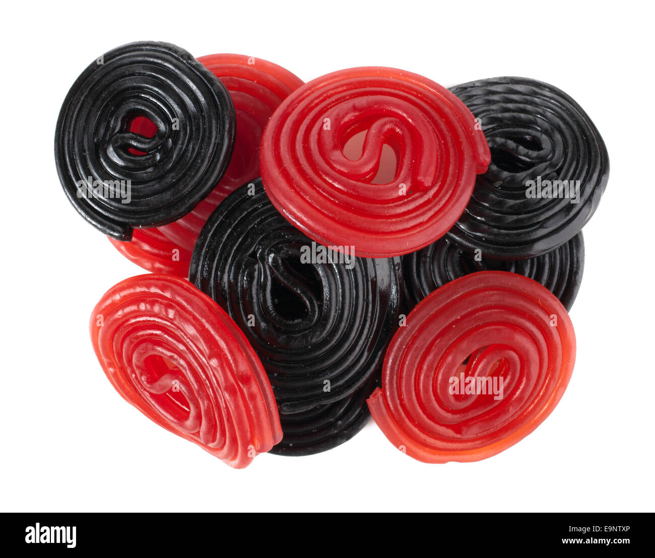 Red and black licorice wheels on a white background Stock Photo - Alamy