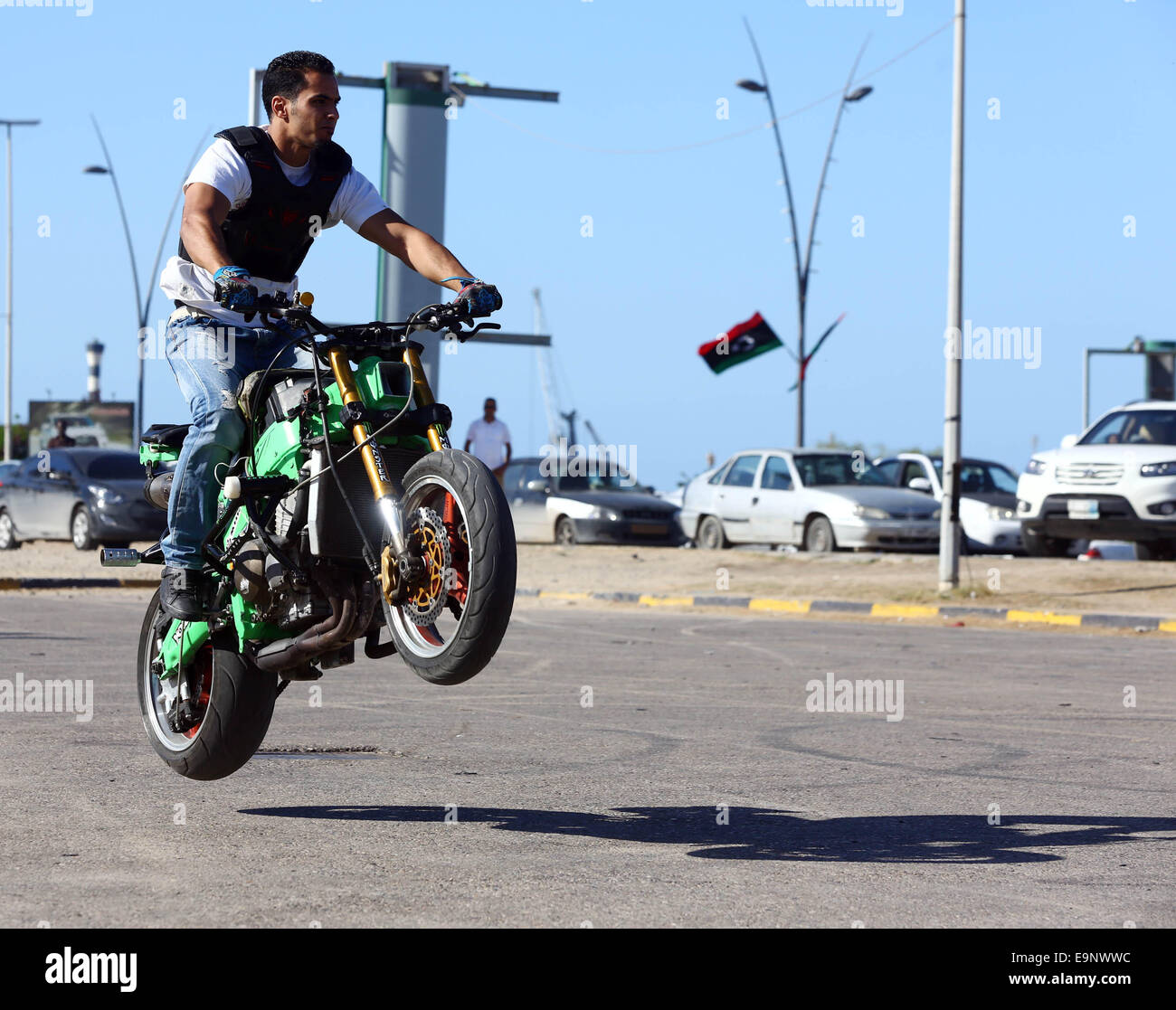 Tripoli, Libya. 30th Oct, 2014. A Libyan young man shows his motorcycle ...