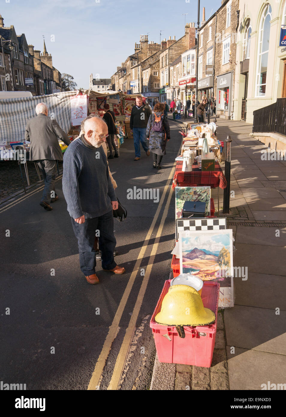 Older man looking at assorted curios at Barnard Castle open air or ...