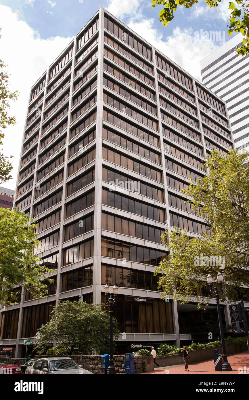 A modern office building with attractive landscaping trees in downtown ...