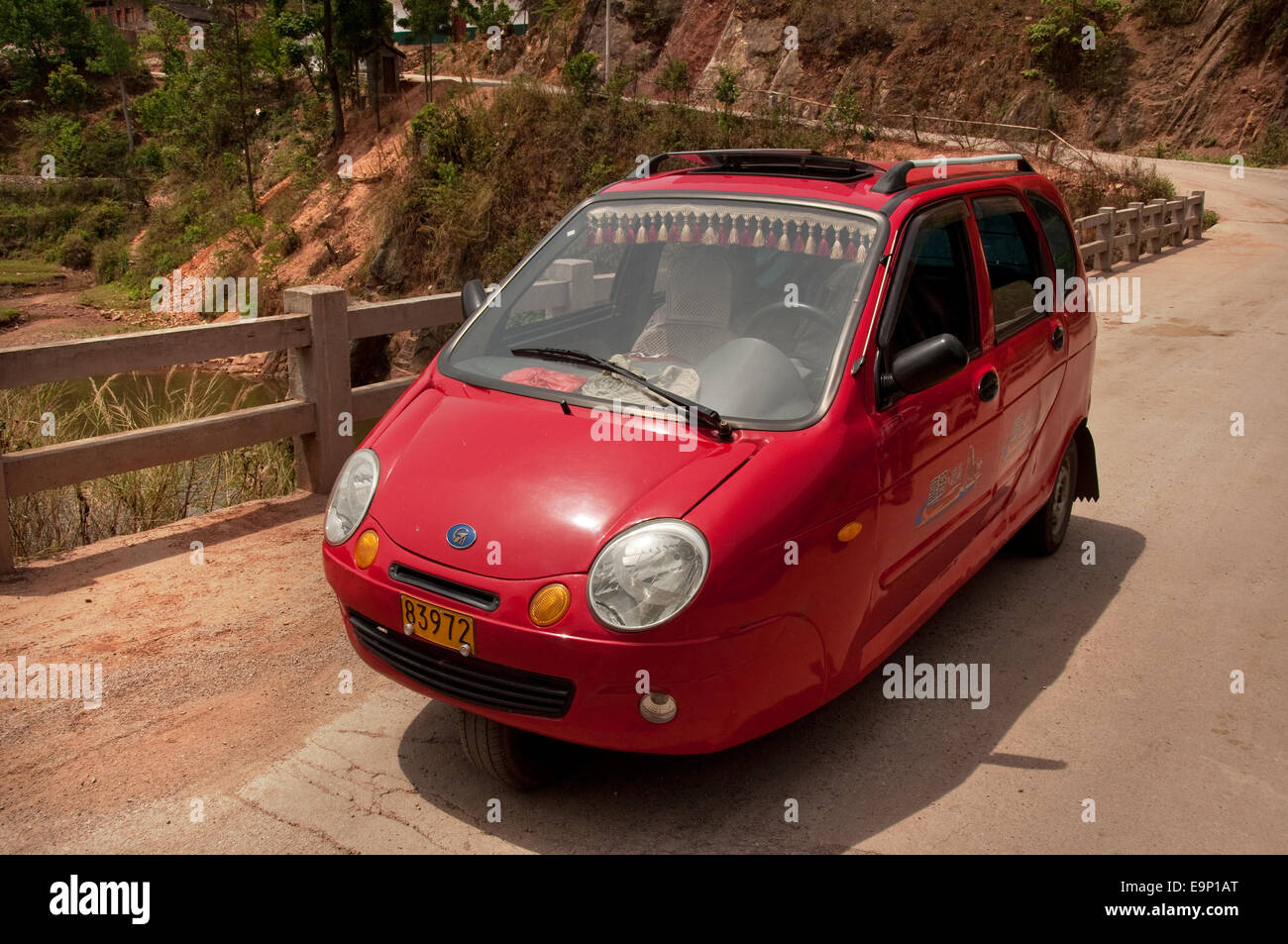 A red three-wheeler, Guizhou Province, China Stock Photo - Alamy