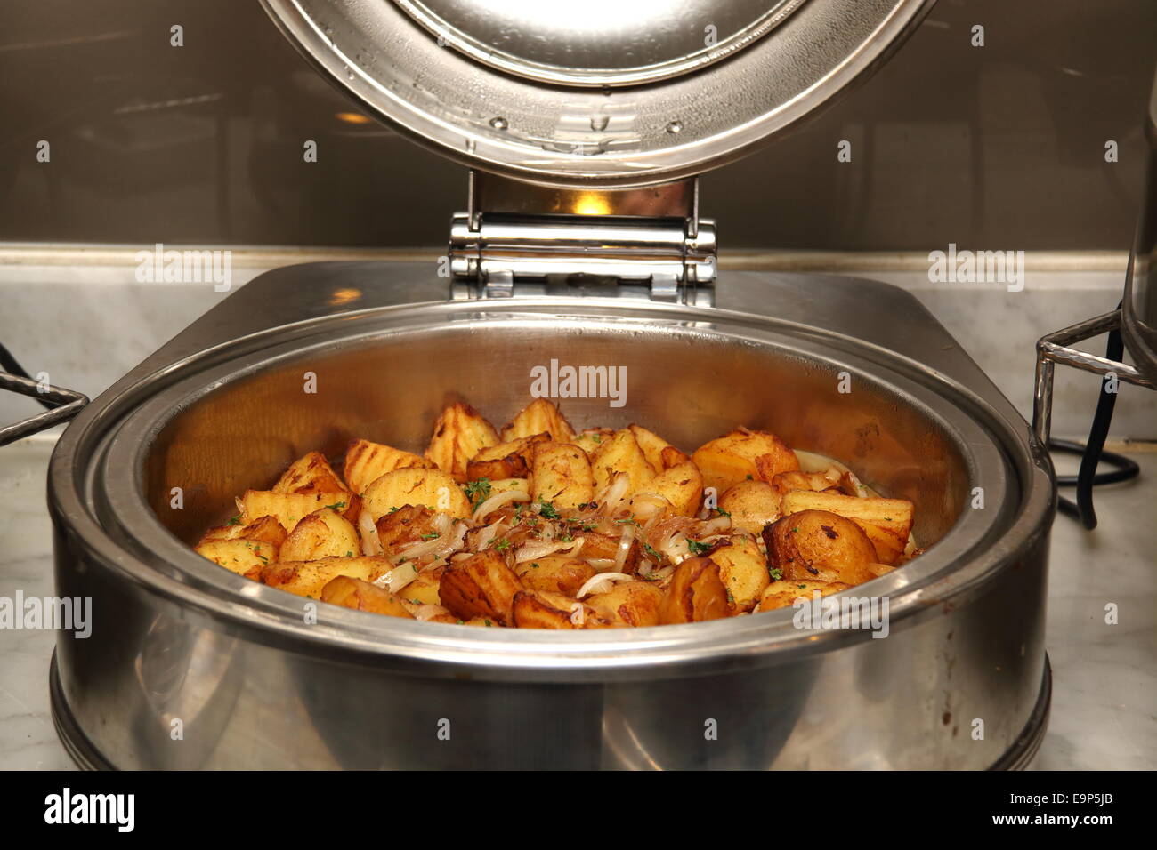 Chafing dish heater filled with ready food inside Stock Photo - Alamy