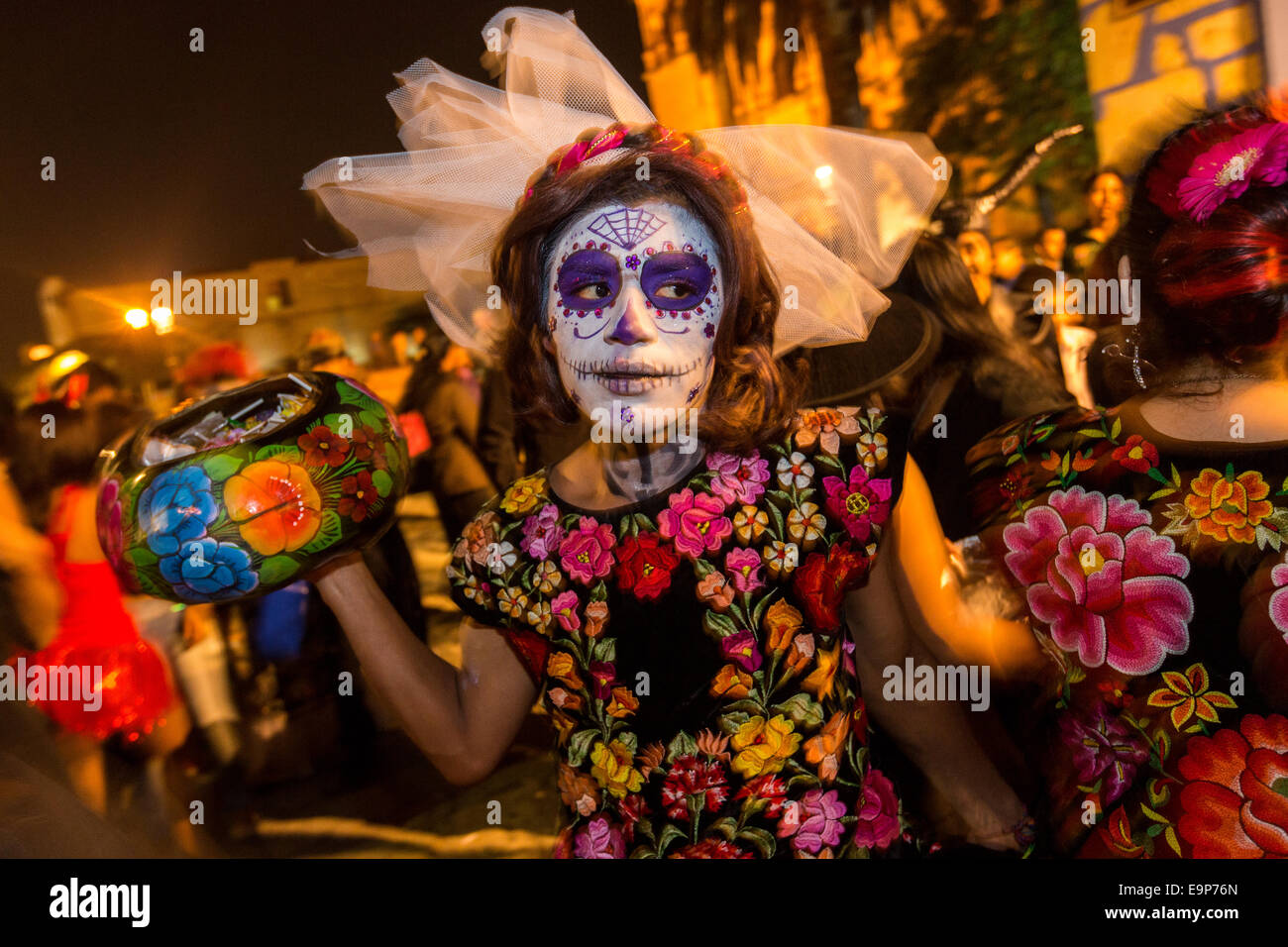 A woman dressed as Catrina, the bride of death, dances during the Day ...