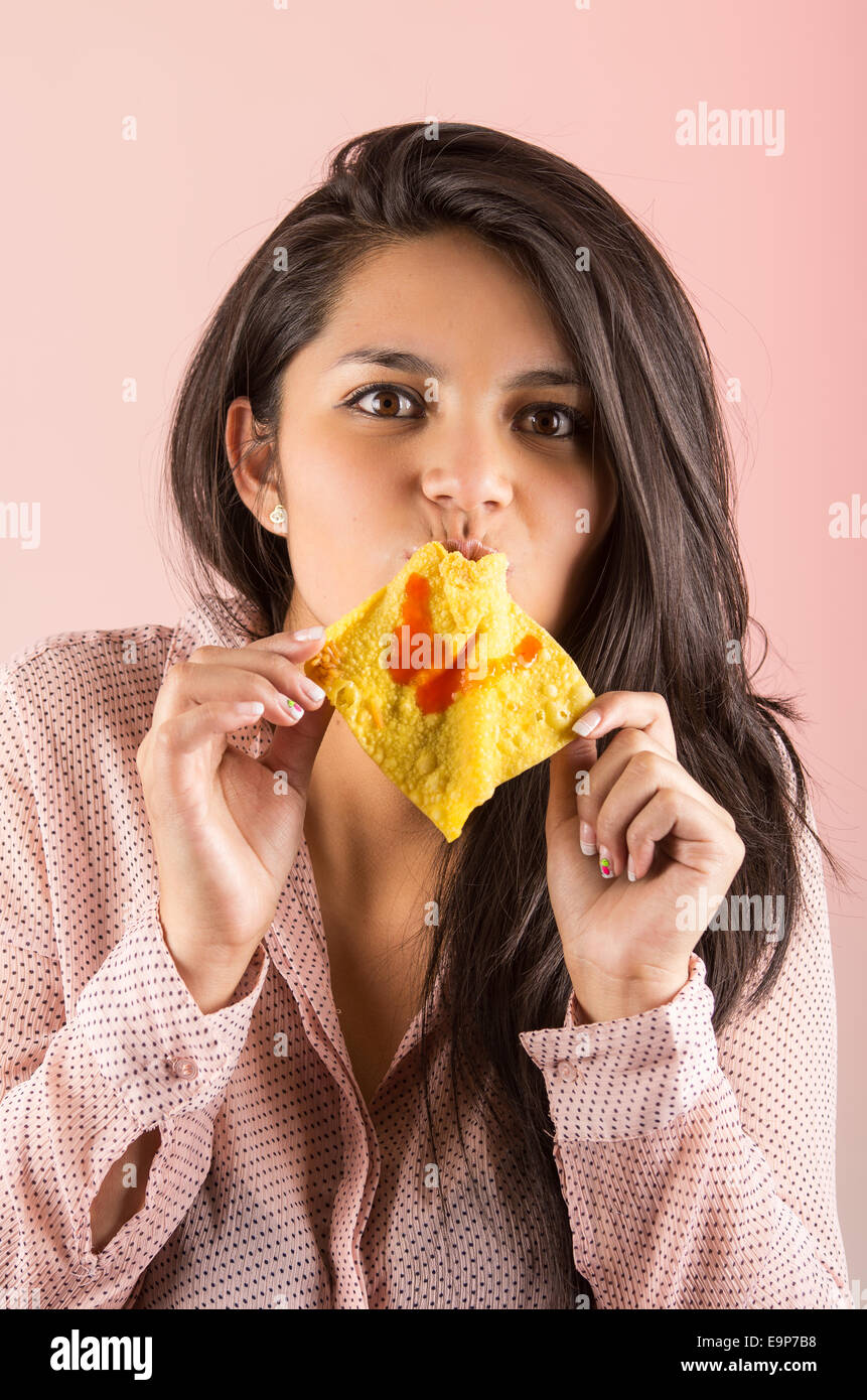 young brunette girl eating chinese wonton cracker snack Stock Photo - Alamy