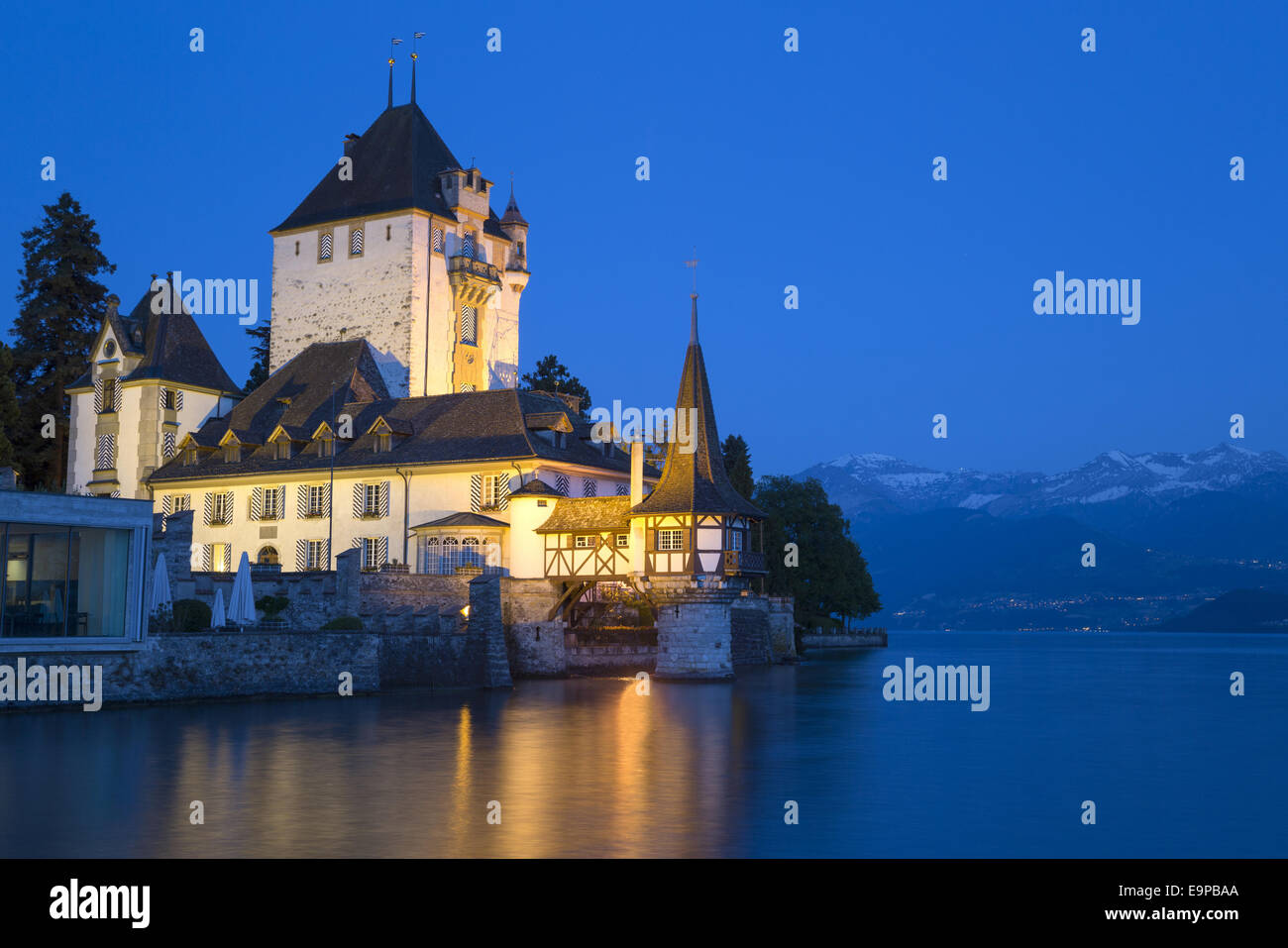 View of lakeside castle illuminated at night, Oberhofen Castle, Lake ...