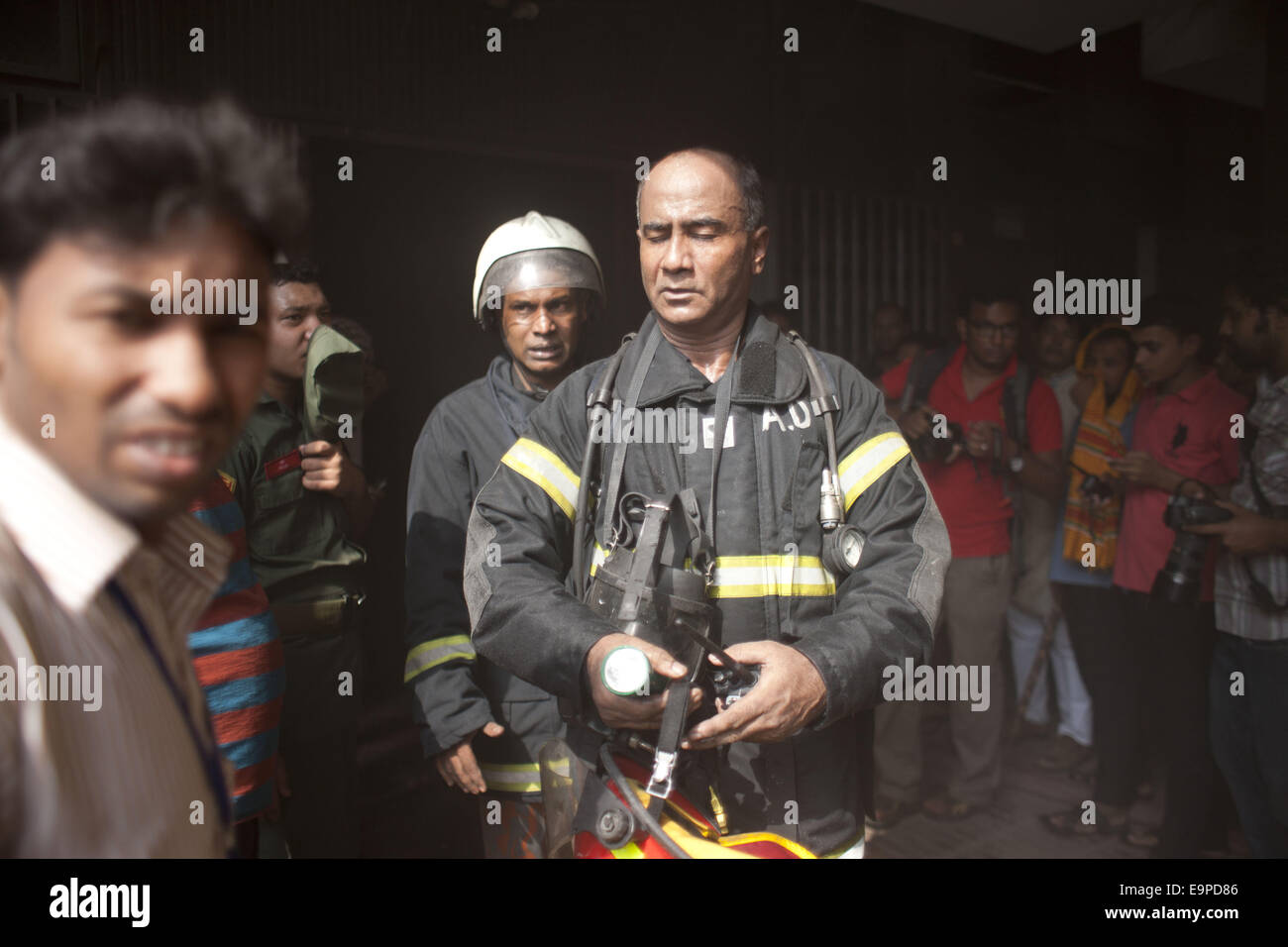 Dhaka, Bangladesh. 31st Oct, 2014. Fire fighters come out from the BSEC ...