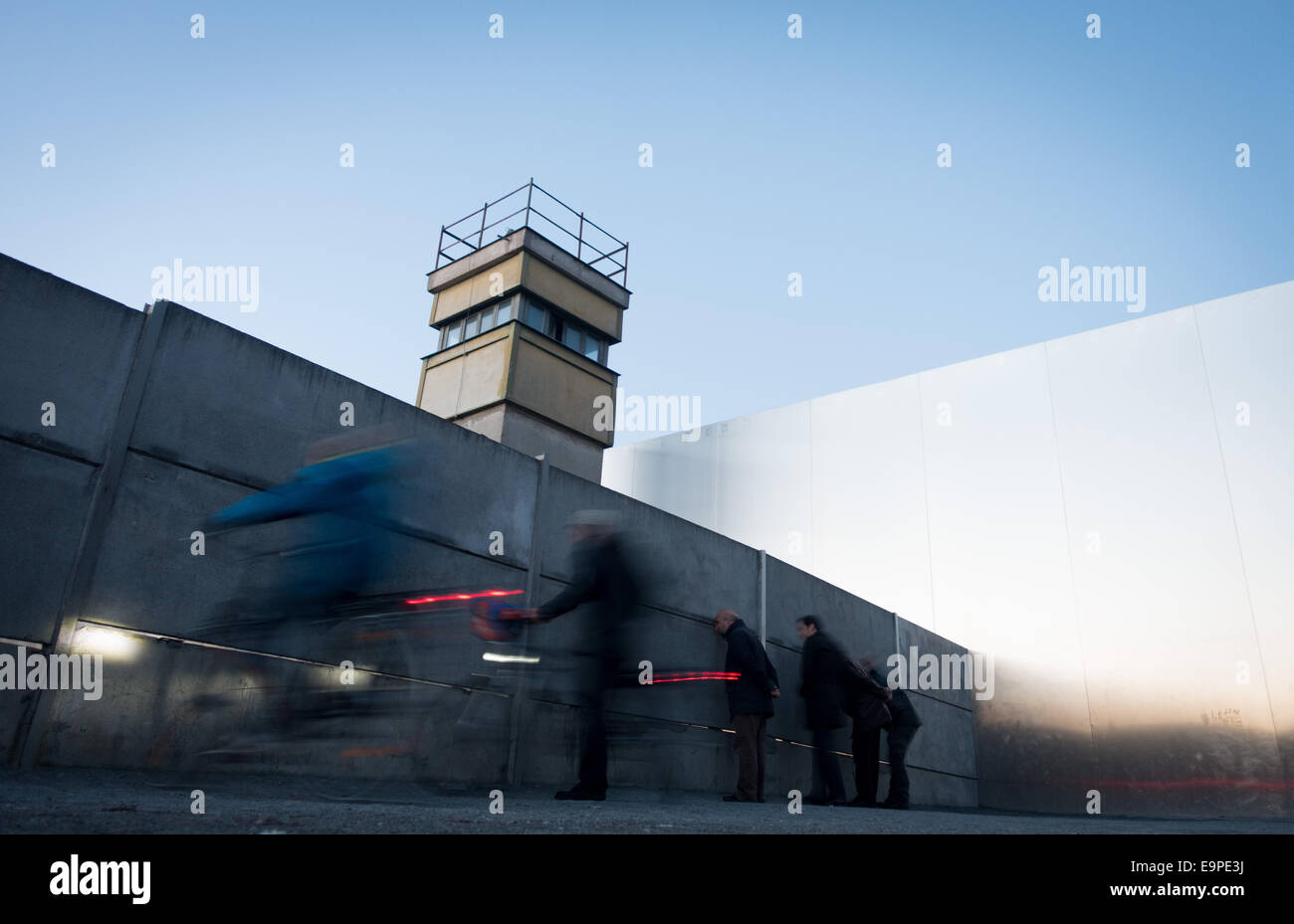 Pedestrians walk past the Berlin Wall memorial site in Berlin, Germany ...