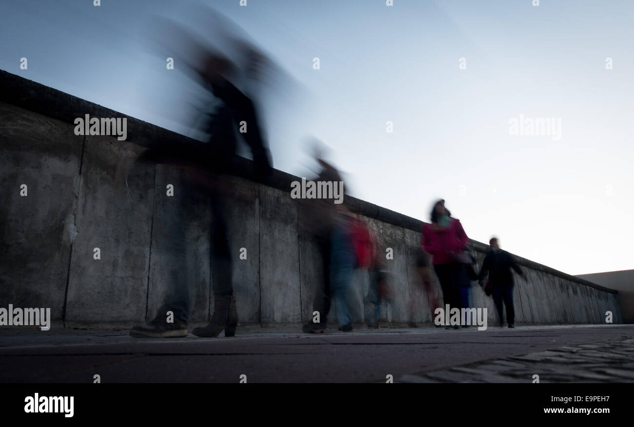 Pedestrians walk past the Berlin Wall memorial site in Berlin, Germany ...