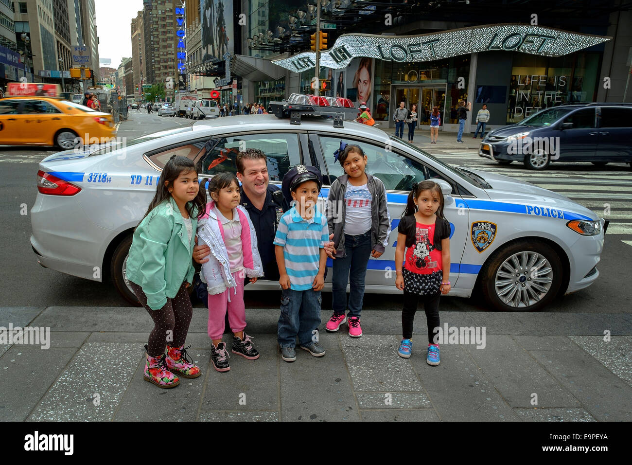 A New York City Police Officer poses with a group of children in New ...