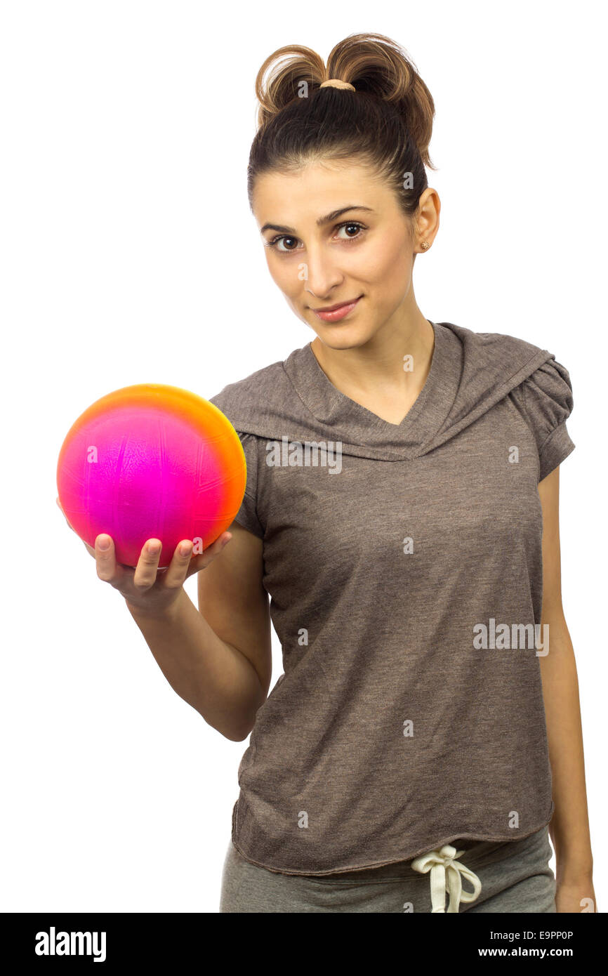 young woman with a colorful ball looking at you over a white background ...