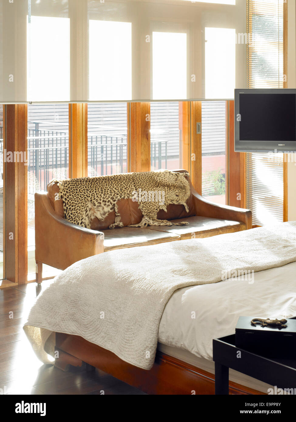 Leopard skin on brown leather sofa in Garden House designed by Studio ...
