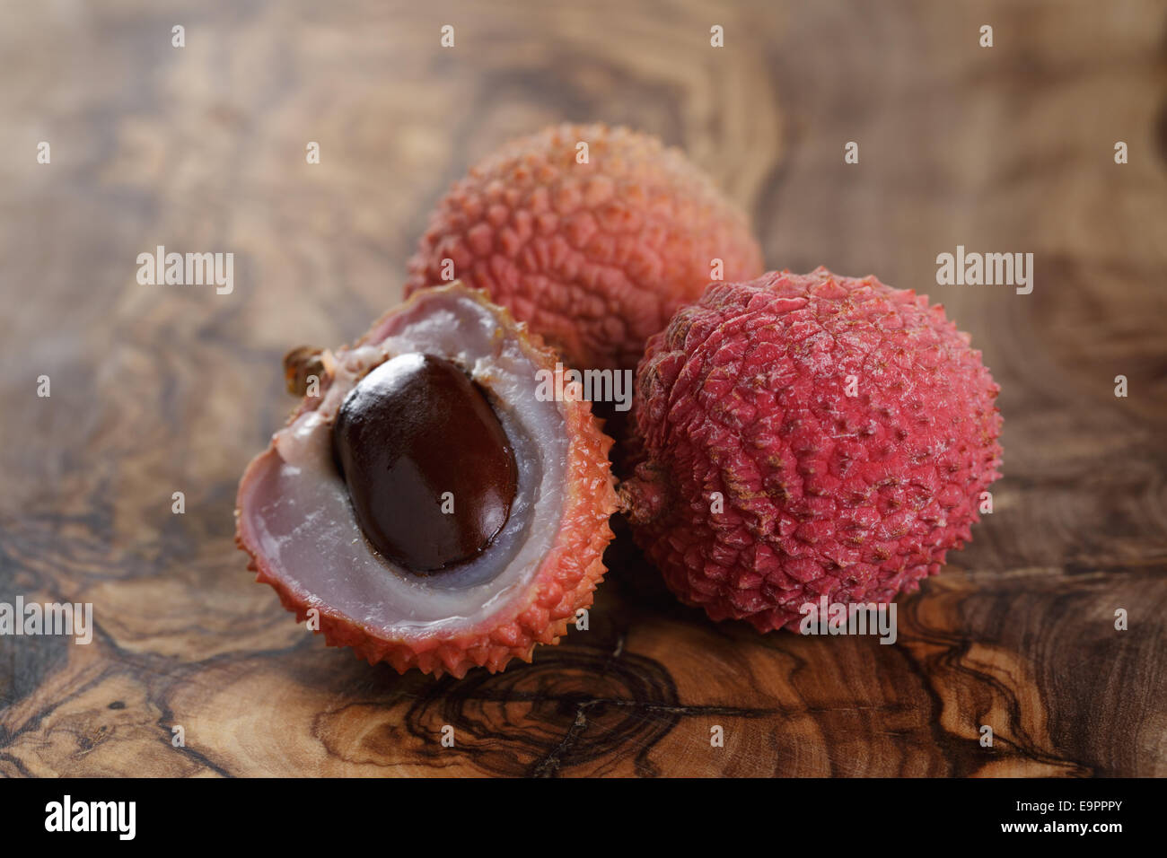 ripe lychee fruits, on olive wood table Stock Photo - Alamy