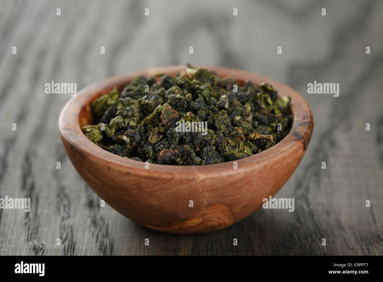 oolong green tea in olive bowl, on oak table Stock Photo - Alamy