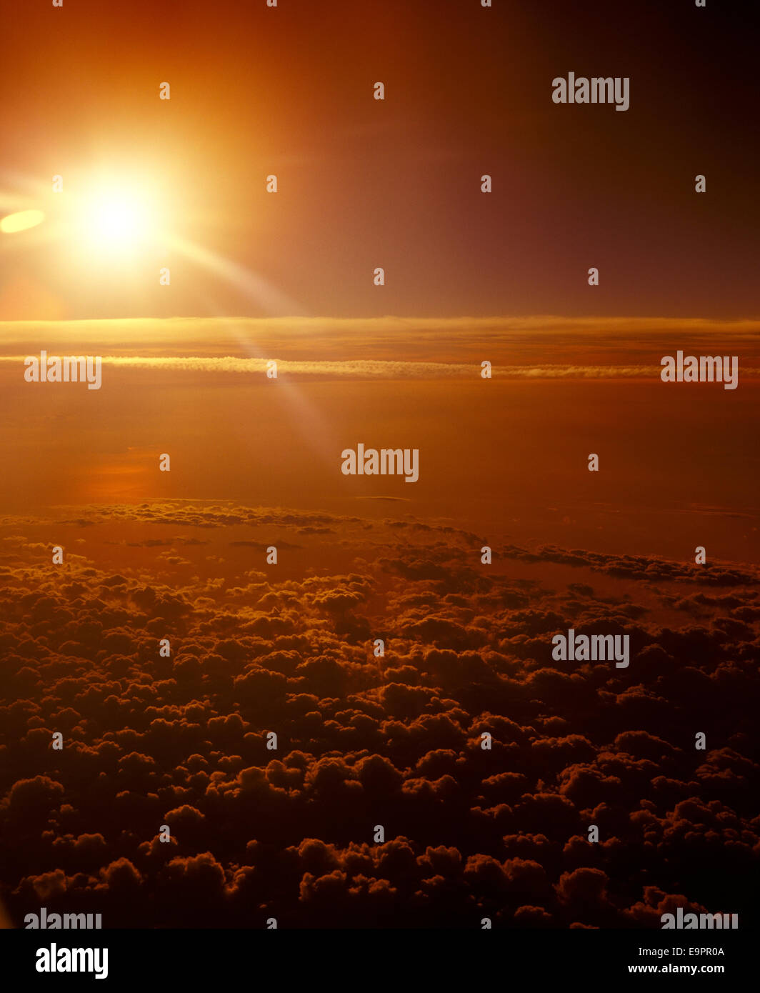 Sunset over a clouds Stock Photo - Alamy