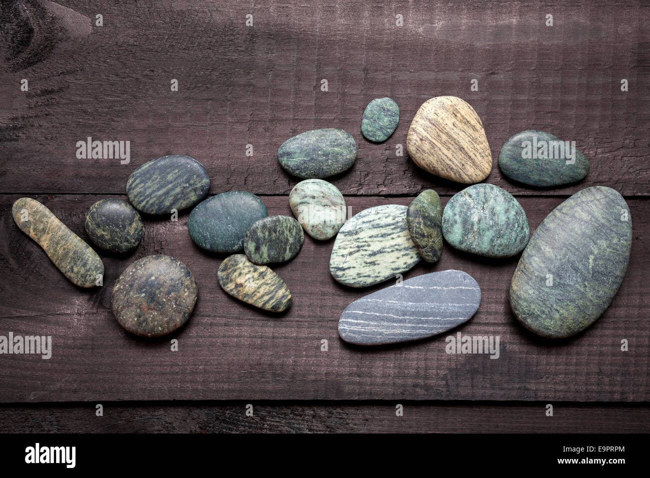 Sea Pebbles on black wooden table Stock Photo - Alamy