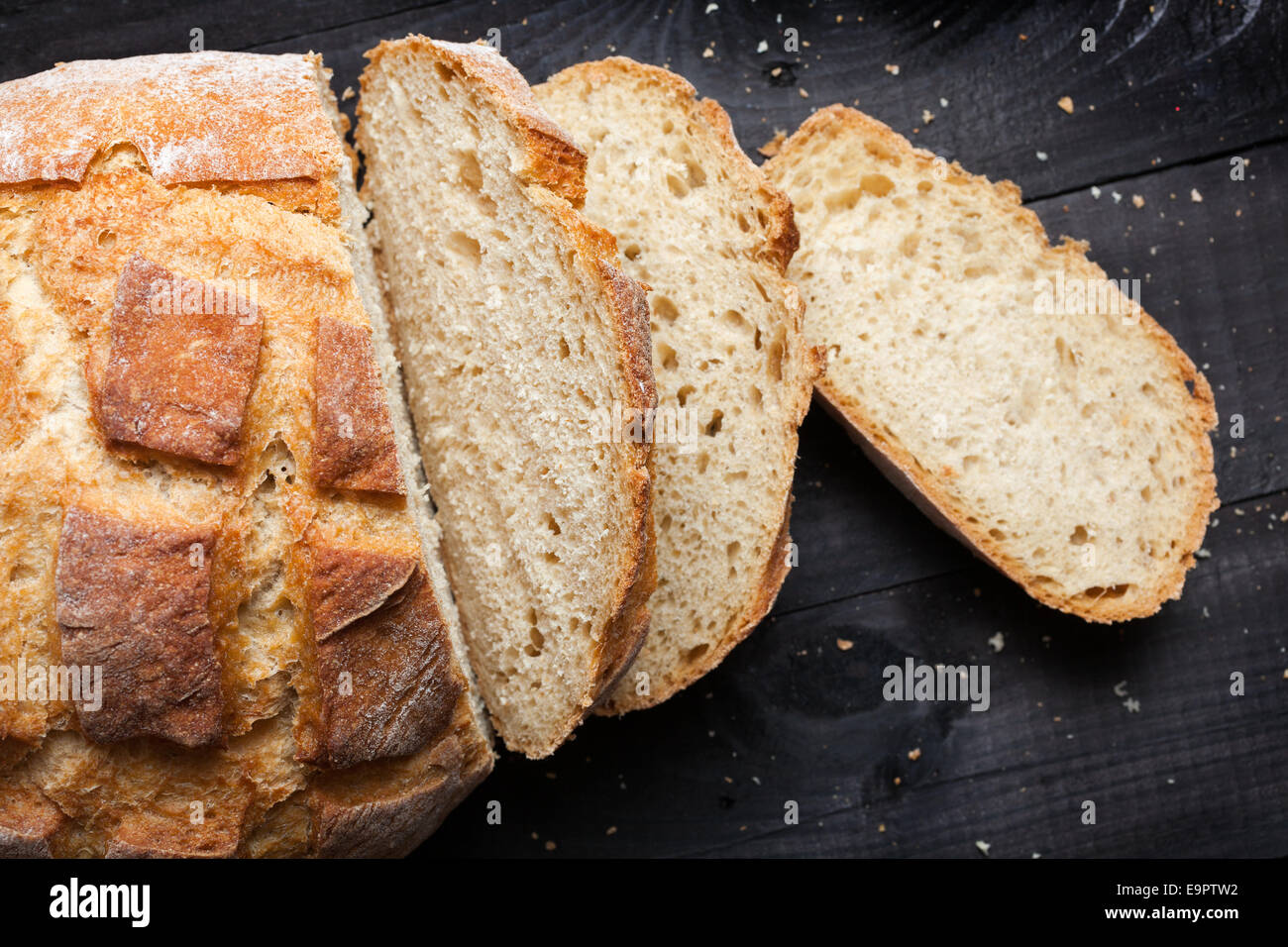 Round loaf bread with some slices cut Stock Photo - Alamy