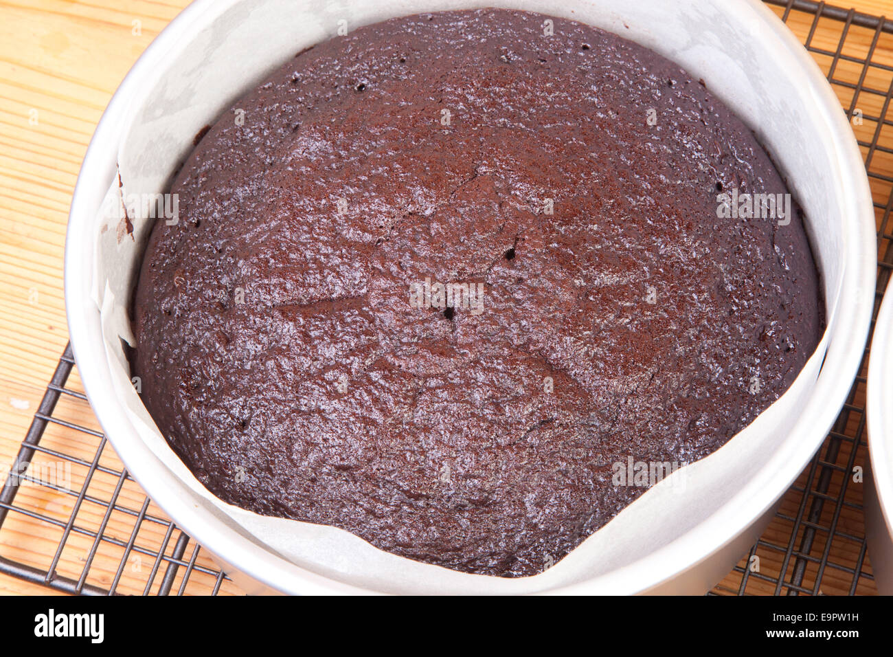 baked chocolate cake in the tin on wire rack Stock Photo - Alamy
