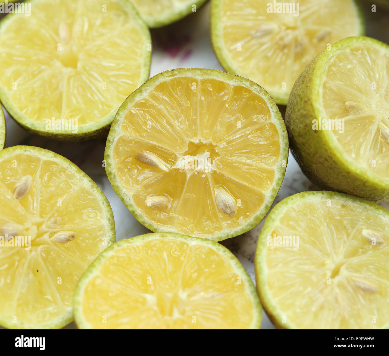 half of green lemon prepare for juice Stock Photo - Alamy