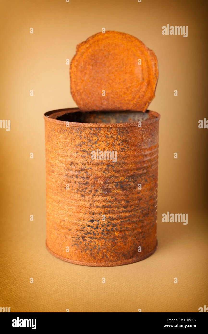 Old rusty tin can on beige background Stock Photo - Alamy