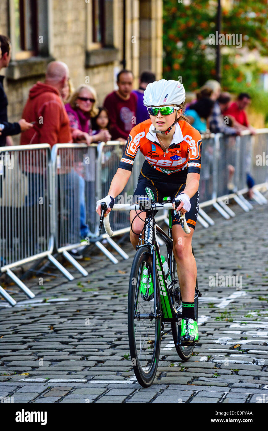 Young female cyclist racing in evening criterium event in Lancaster ...