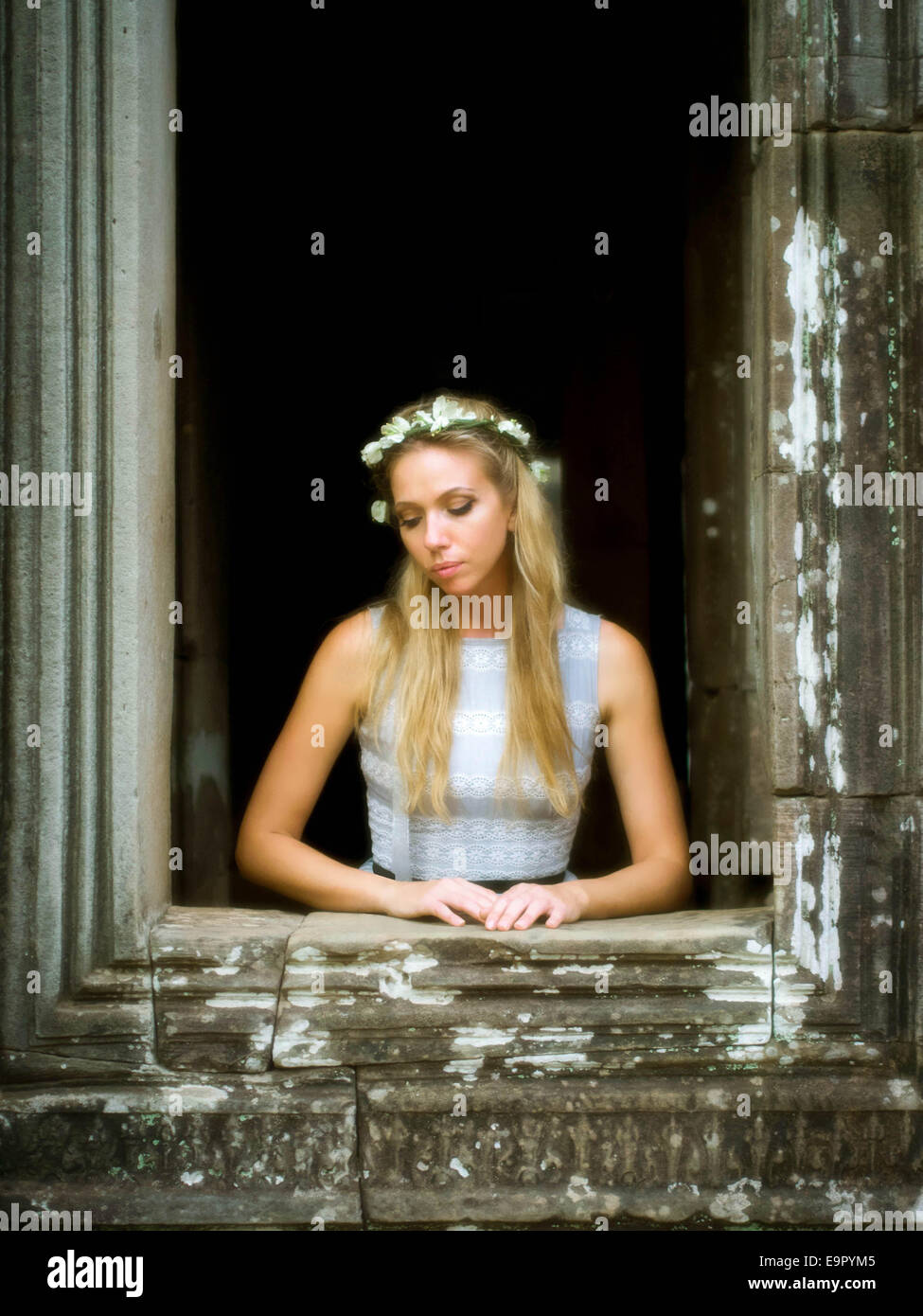 Lonely fairytale princess looking down from medieval tower window ...