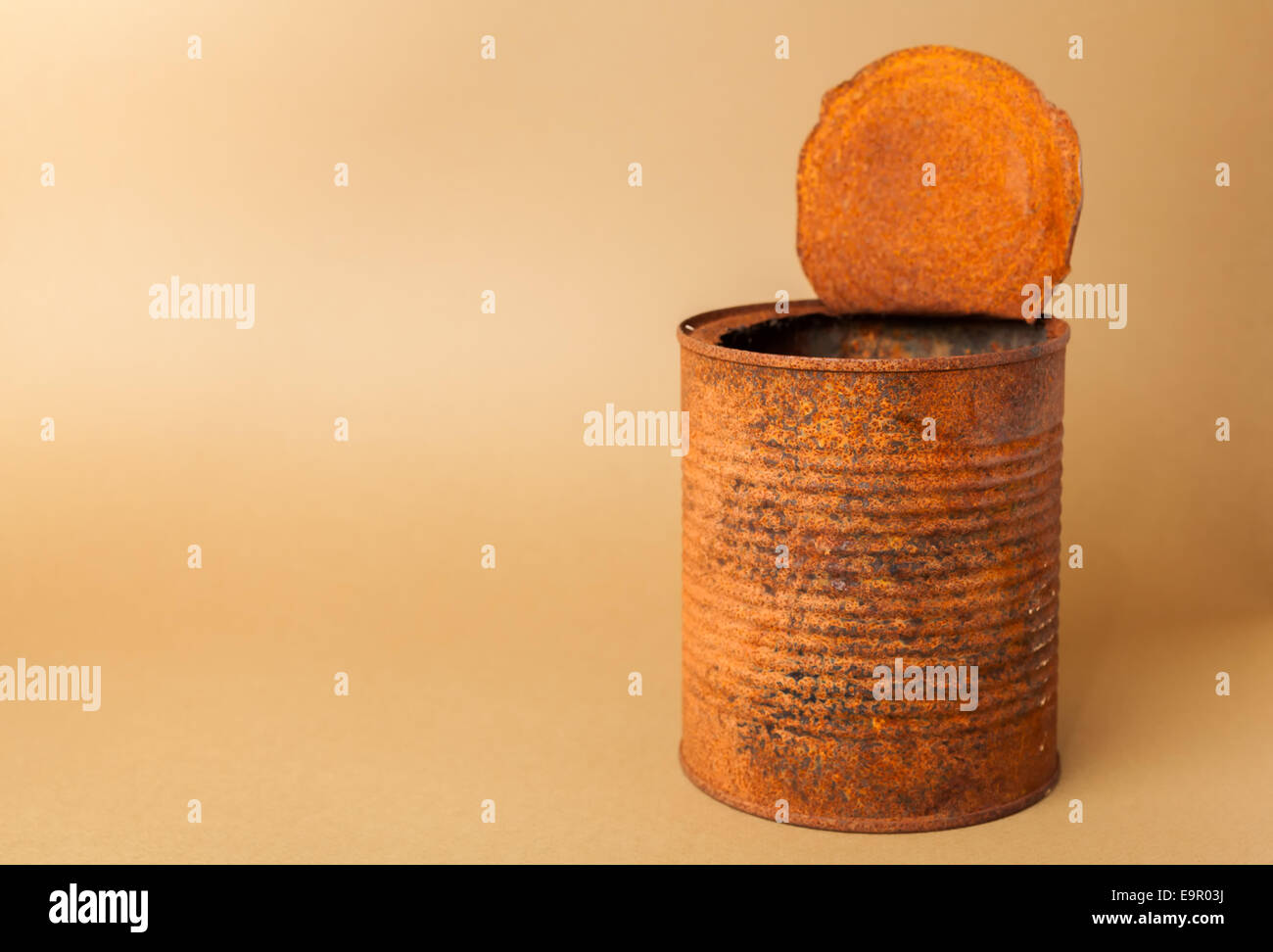 Old rusty tin can on beige background Stock Photo - Alamy