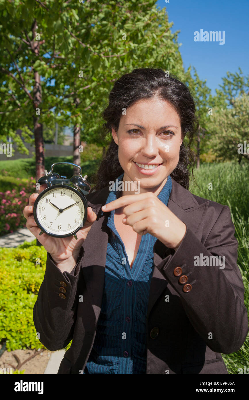 businesswoman with big clock in exterior background Stock Photo - Alamy