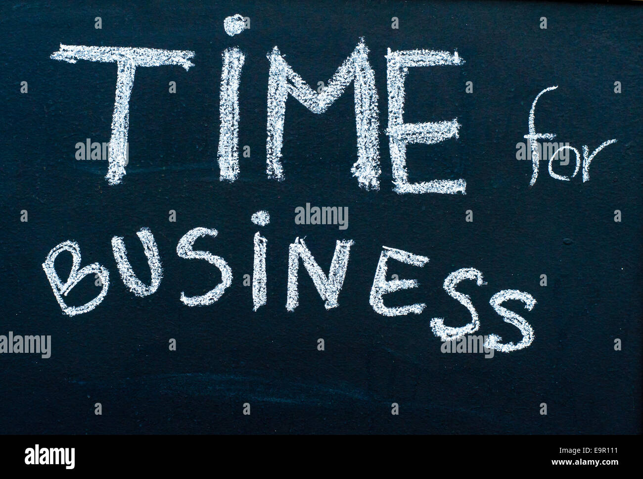 Time for business message handwritten with white chalk on blackboard ...