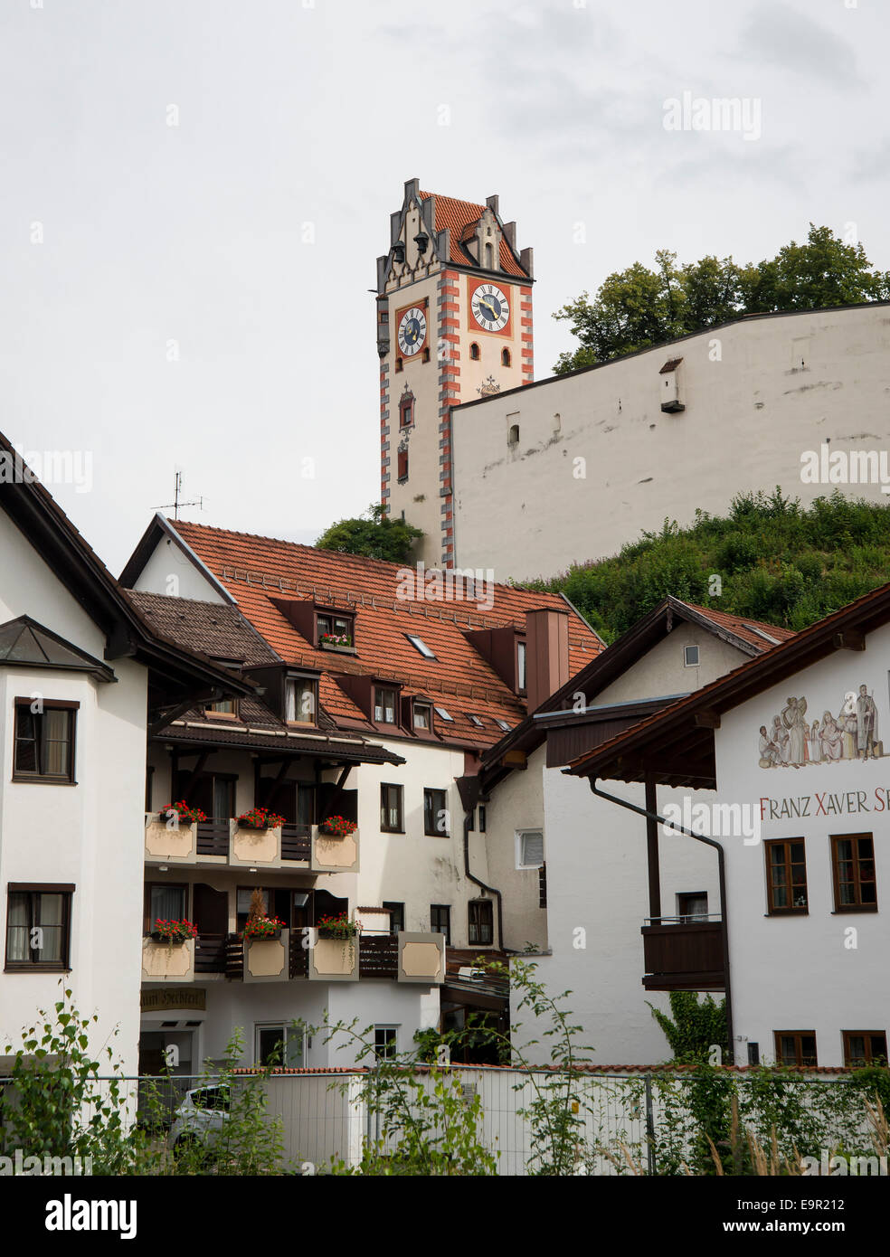 Vertical image of Fussen with old houses and St. Mang Basilica tower ...