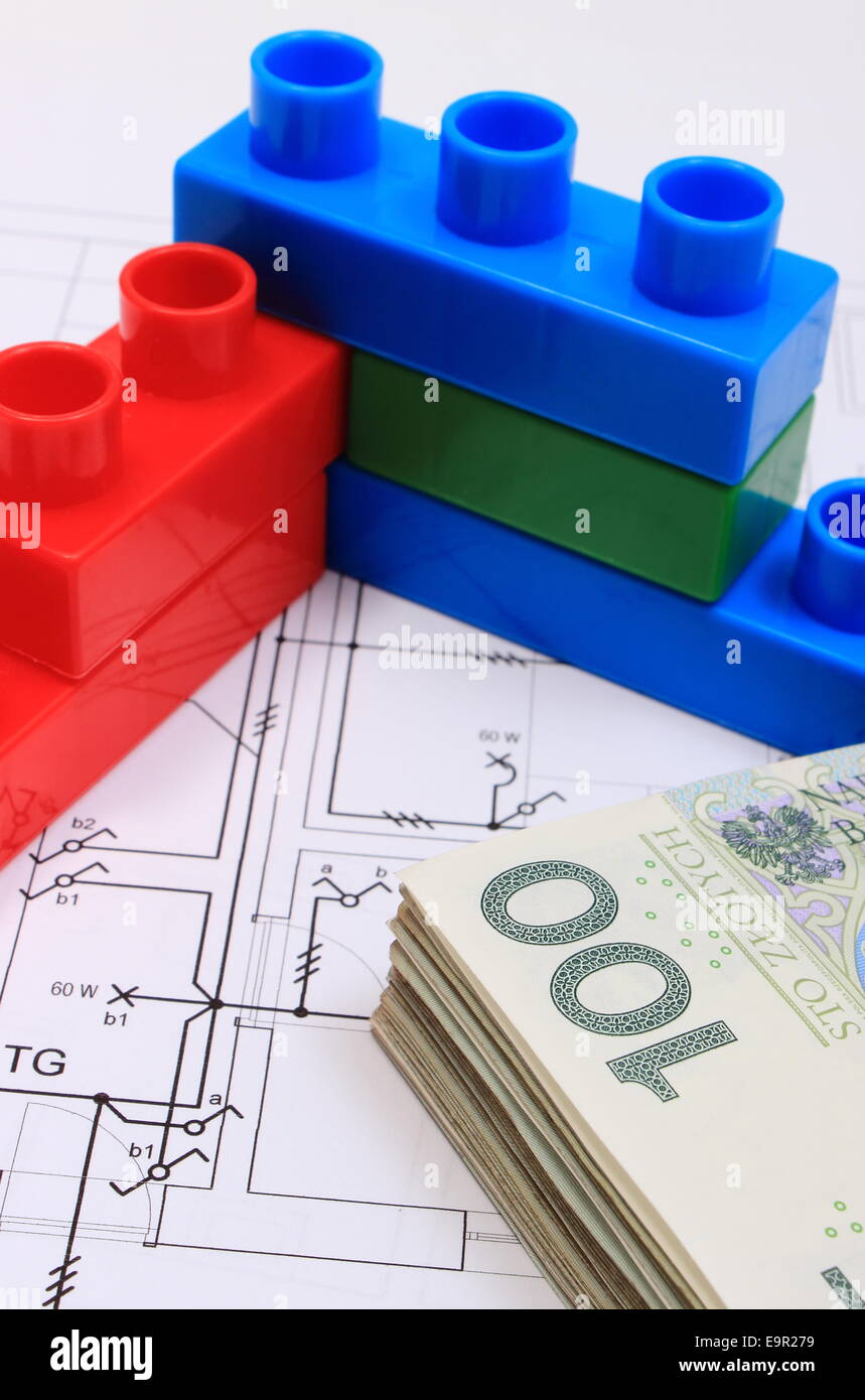 Heap of banknotes and wall of plastic colorful building blocks lying on ...