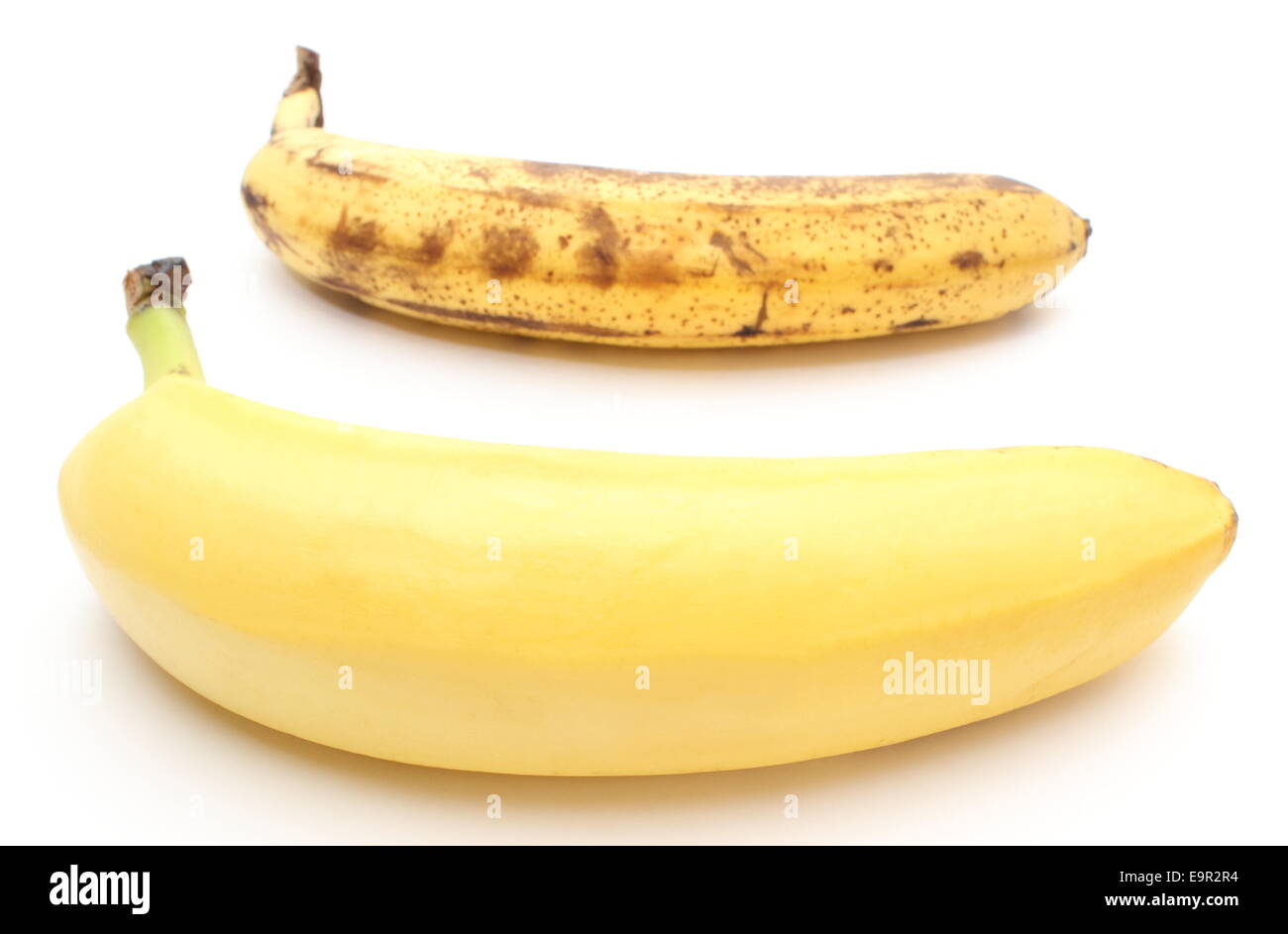 Closeup of two bananas - fresh and overripe. Isolated on white ...