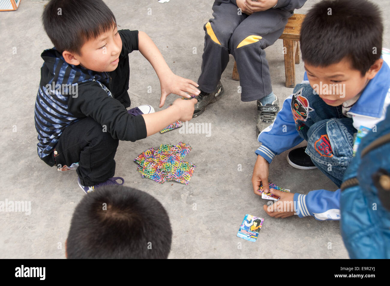 Children playing cards on the street, Shidong, Guizhou Province, China ...