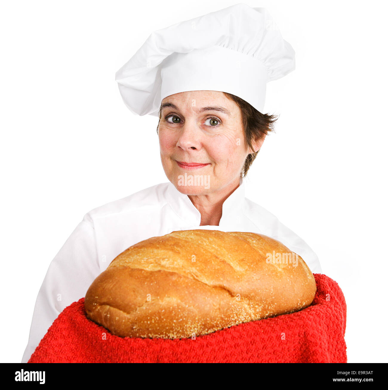 Pretty female bakery chef holding a loave of freshly baked bread ...