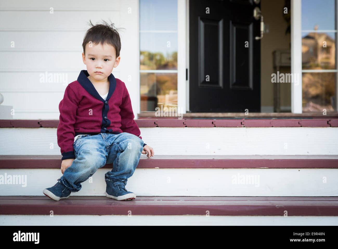 Cute Melancholy Mixed Race Boy Sitting on Front Porch Steps Stock Photo ...