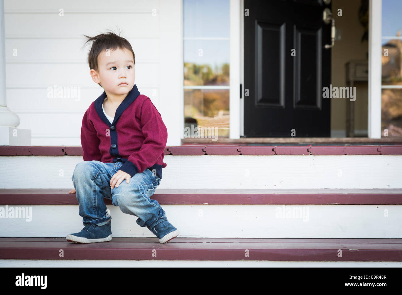 Cute Melancholy Mixed Race Boy Sitting on Front Porch Steps Stock Photo ...