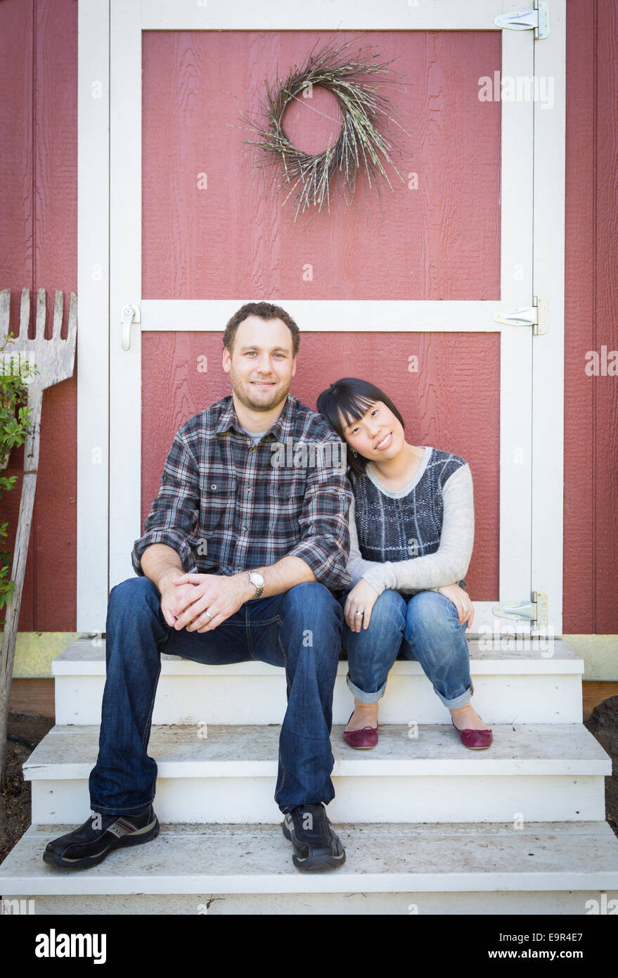 Happy Mixed Race Couple Relaxing on the Steps of Their Barn Stock Photo ...