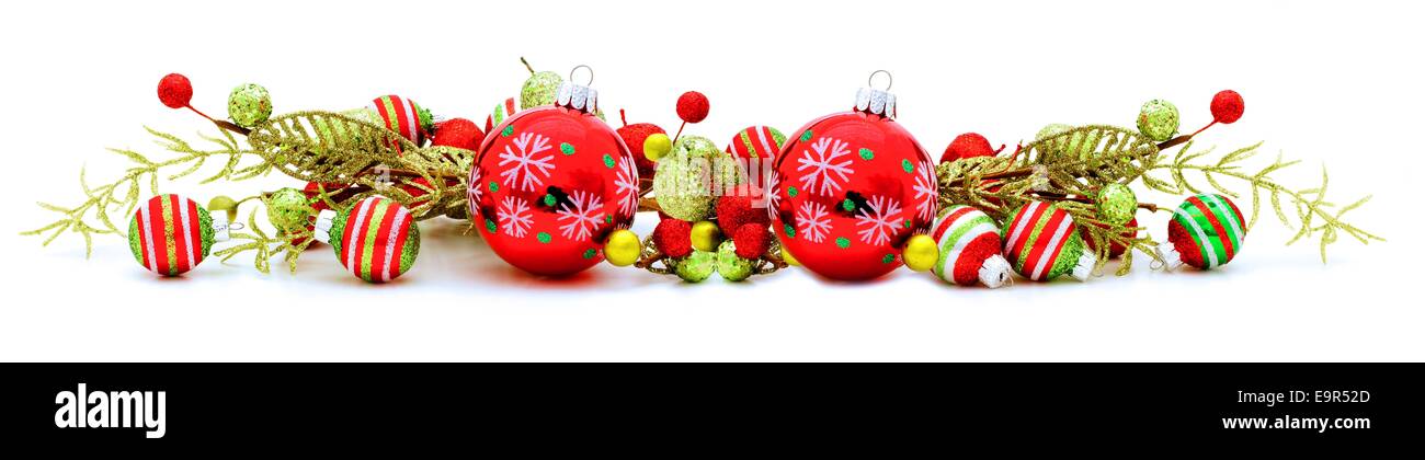 Long Christmas border with baubles and branches over a white background ...