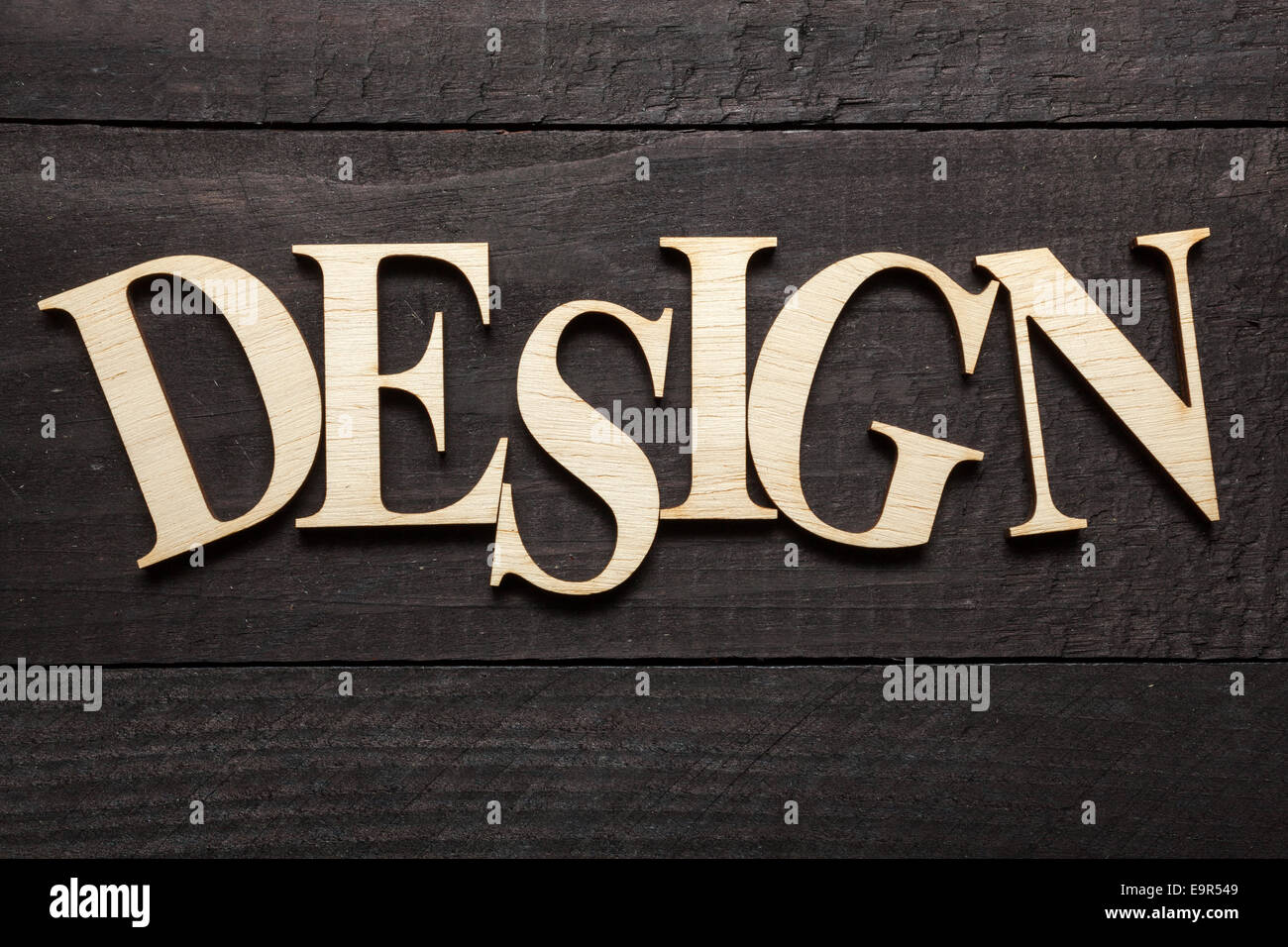 Wooden letters forming word DESIGN written on black wooden background ...