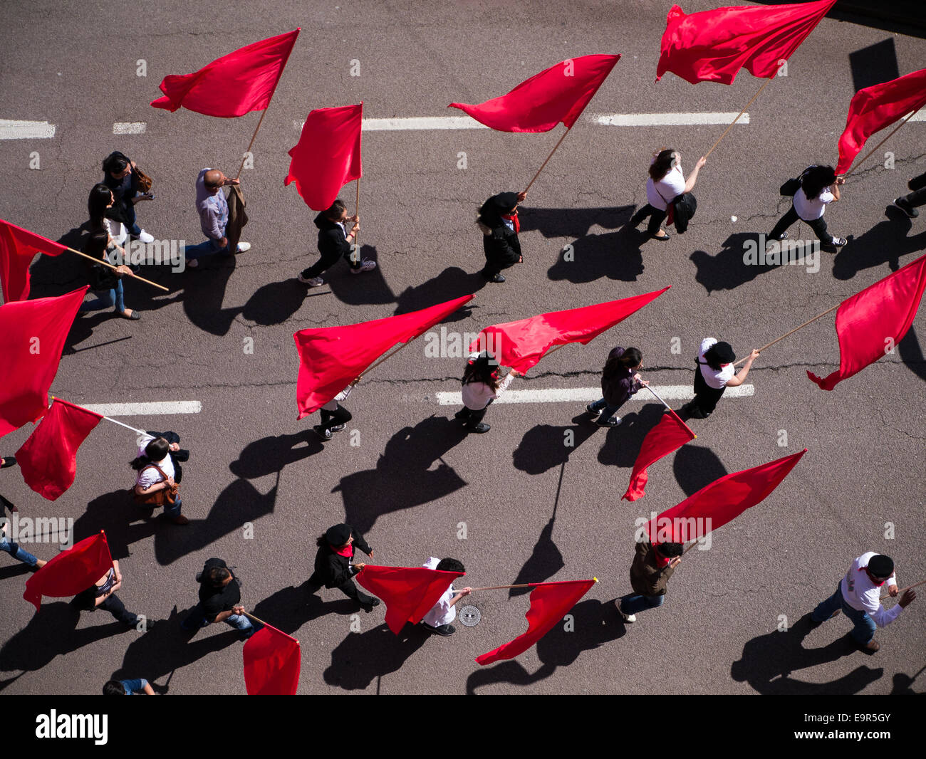Protesters march with red flags Stock Photo - Alamy